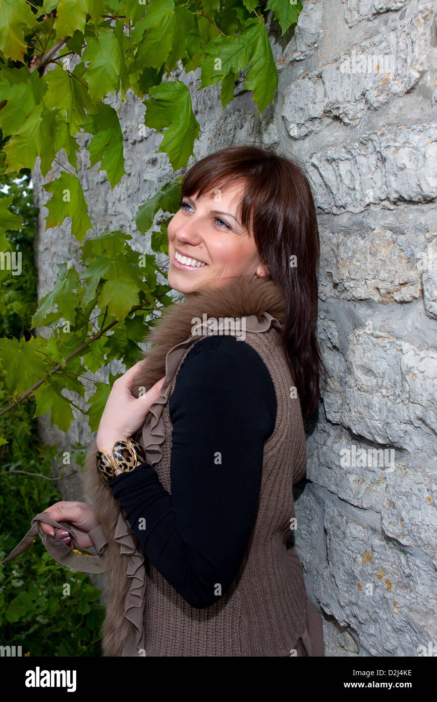 Beautiful Blue Eyed Smiling Girl Outdoors Near The Wall And Maple Stock