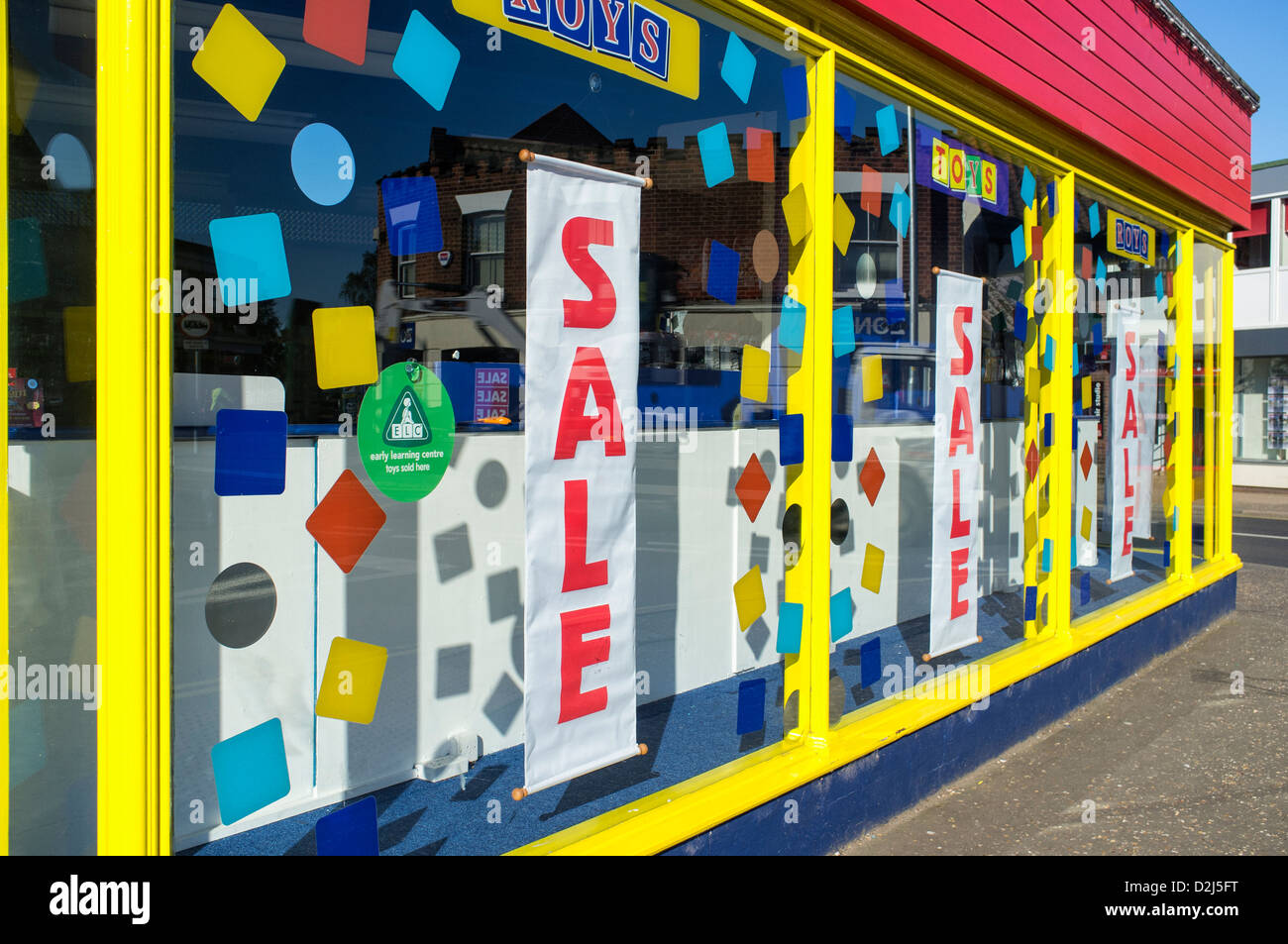 Sale Sign in Window of Brightly Painted Toy Shop Stock Photo - Alamy
