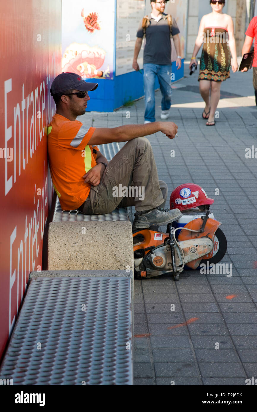 Construction worker waiting for a ride home from the base of the CN ...