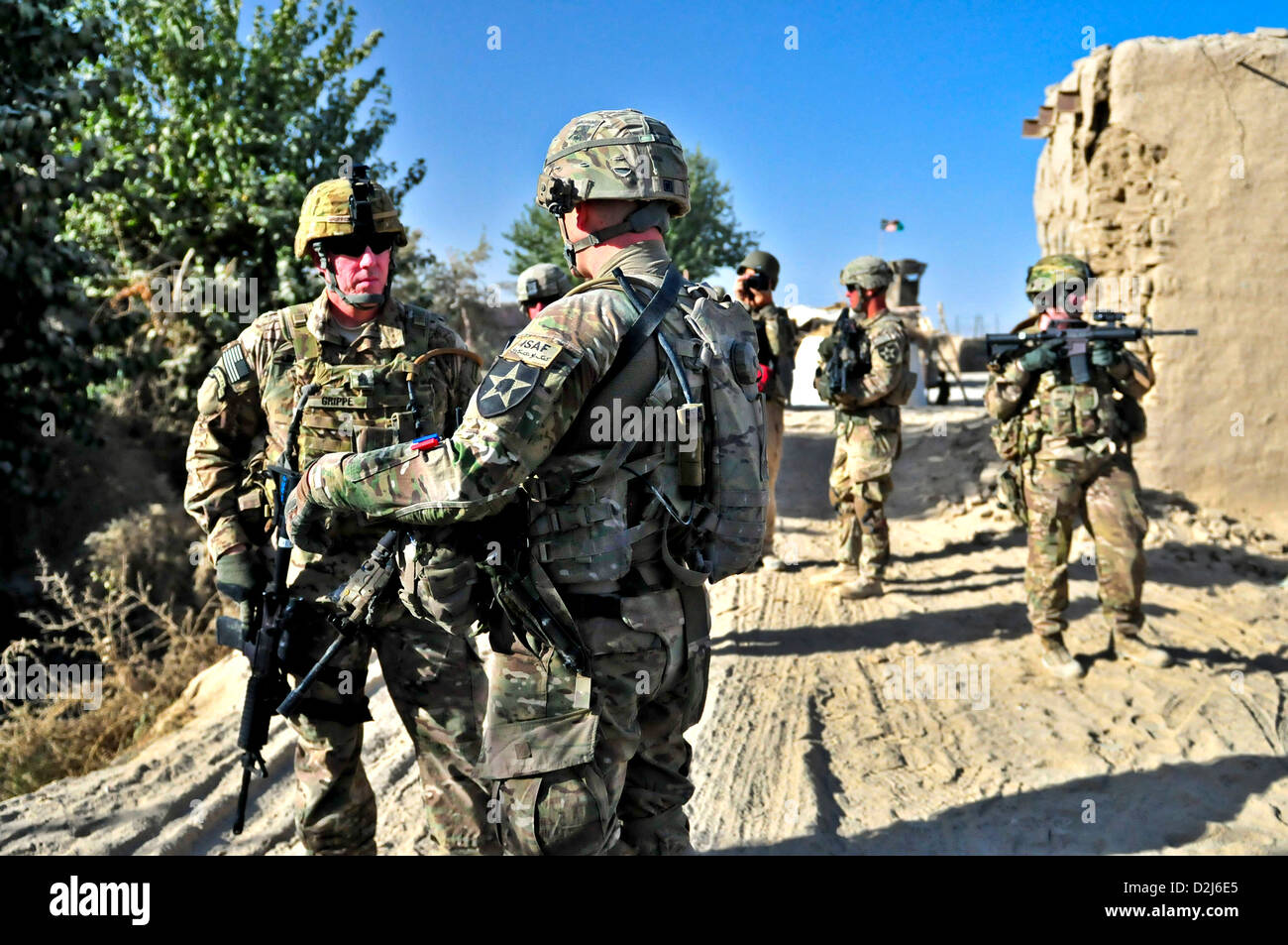 Command Sergeant Major Frank Grippe speaks with soldiers on a foot ...