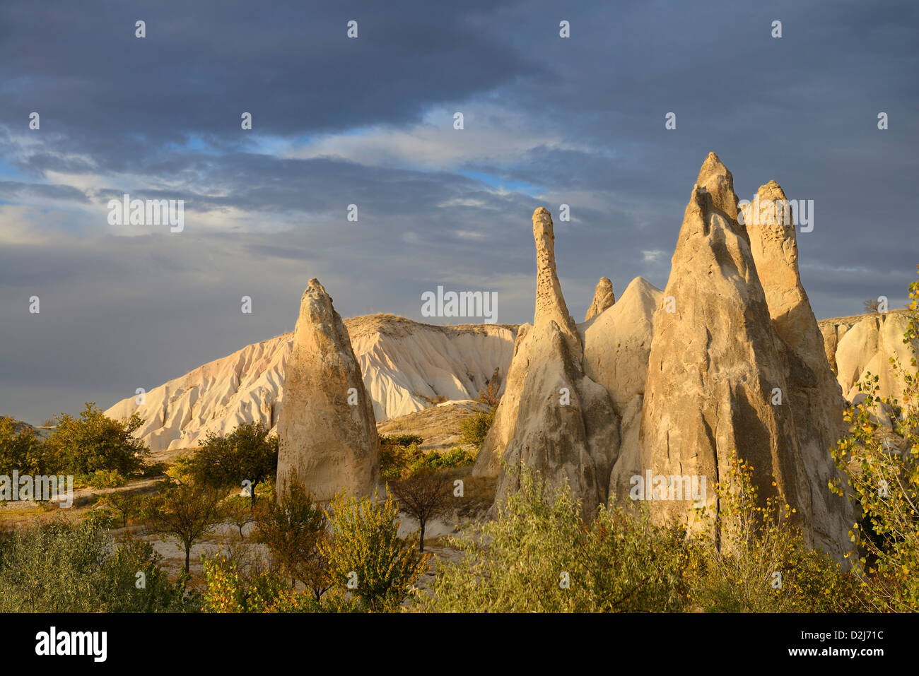 Evening sun on eroded rock spires of the Red Valley Cappadocia Nevsehir ...