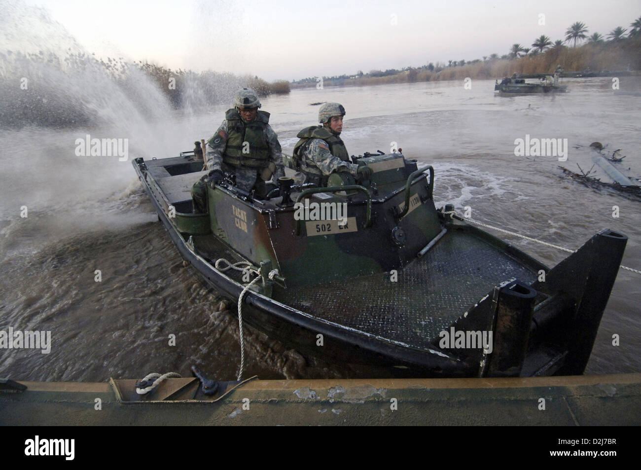 US Army Soldiers pull a section of an assault float bridge away so ...
