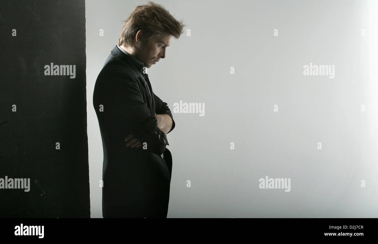 Thoughtful handsome, young guy staring at the floor Stock Photo - Alamy