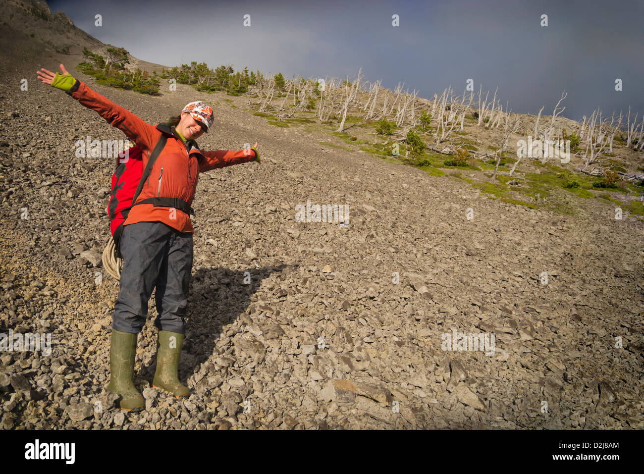 Female caver celebrating on a mountainside; coleman alberta canada ...