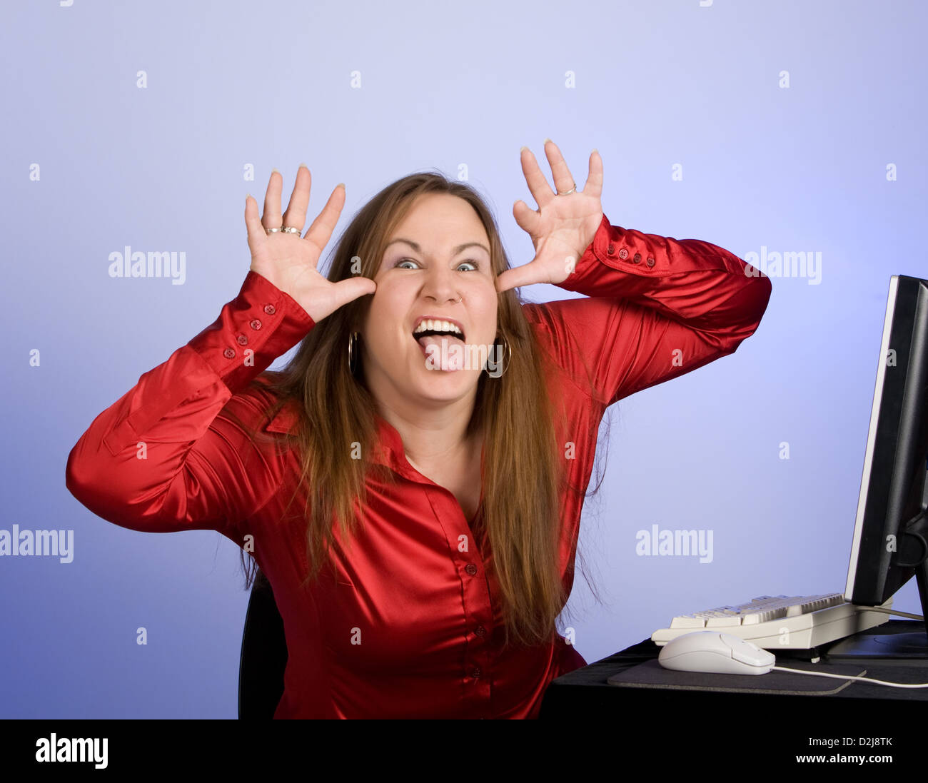 Female office worker making a face while sitting at their desk Stock ...