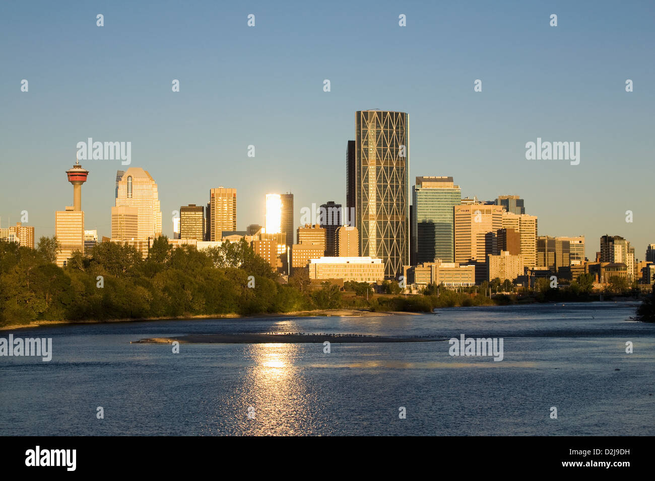 Calgary cityscape along river with reflections on building and river at ...