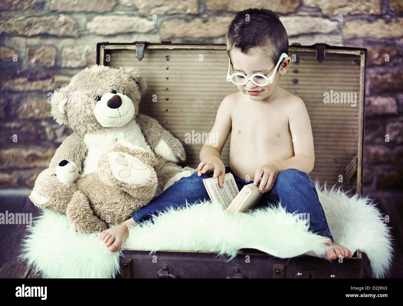 Cute kid boy trying to read Stock Photo - Alamy