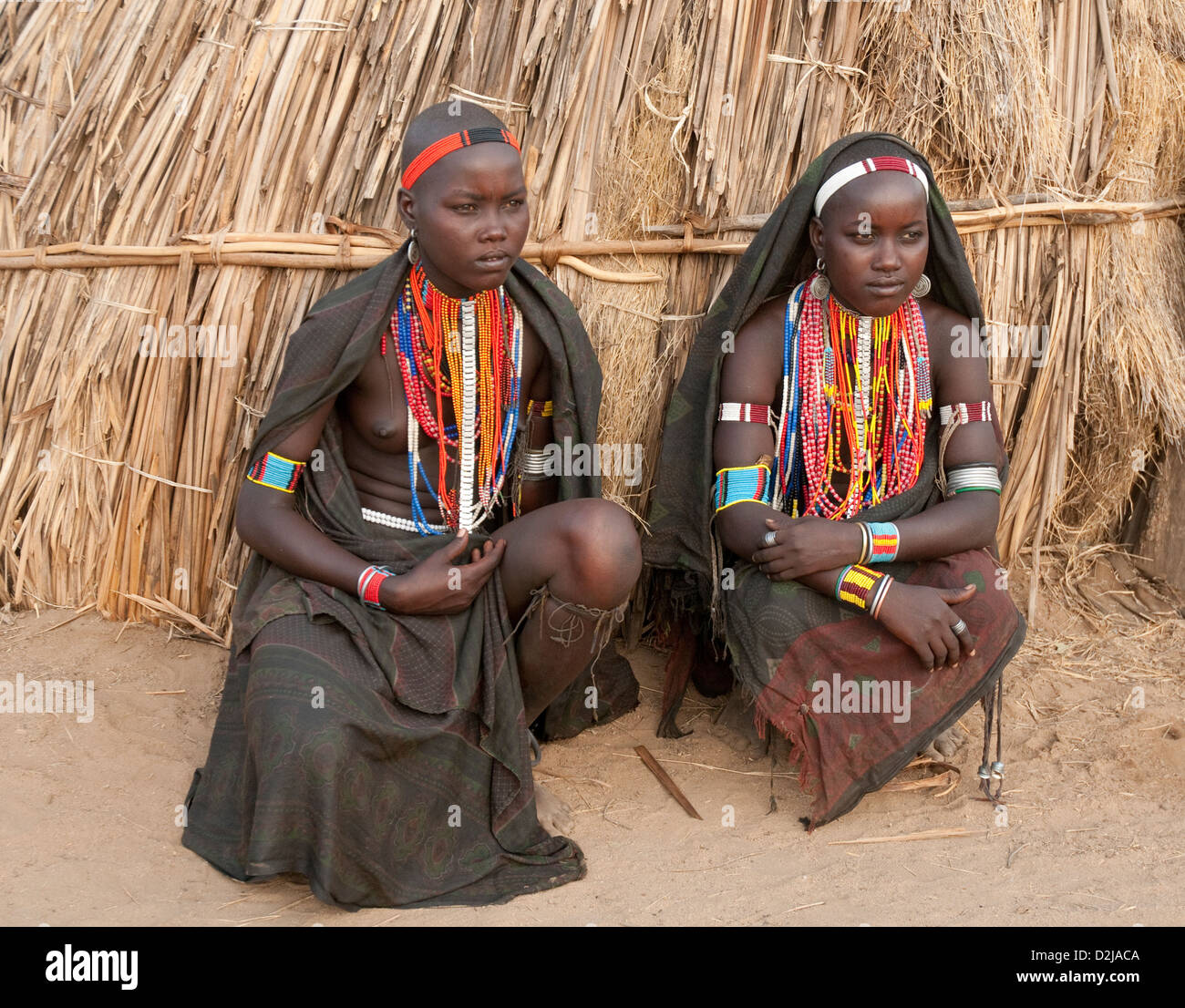 Portrait of two Arbore women sitting in front of hut Stock Photo - Alamy