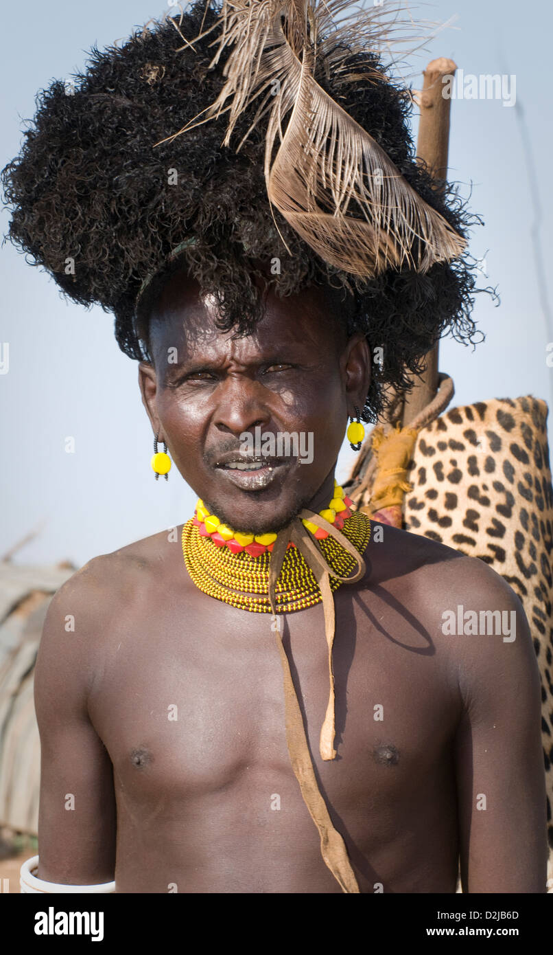 Portrait of Dassebech chief with feathered headdress in front of pole ...