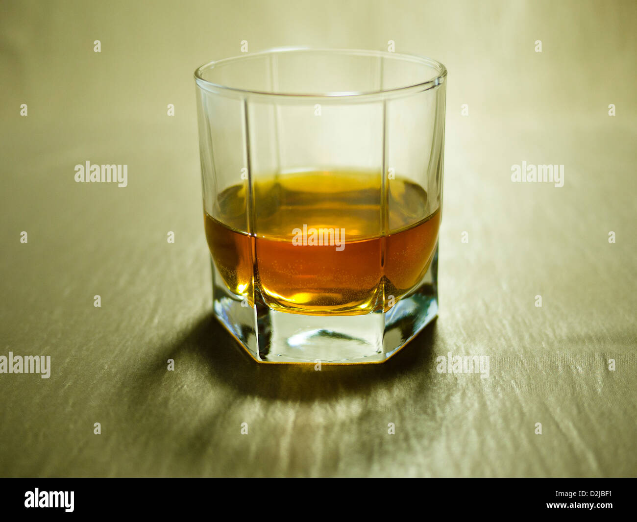 Glass beaker of cold whisky with ice Stock Photo - Alamy