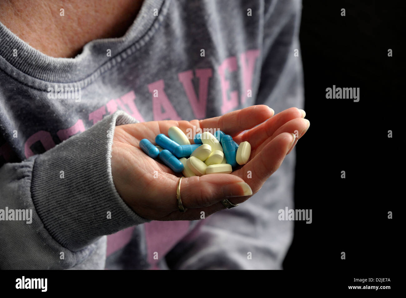Female holding tablets Stock Photo - Alamy