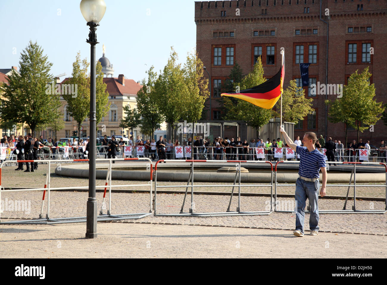 Potsdam, Germany, a protester waves the Germany flag on the DVU Stock ...