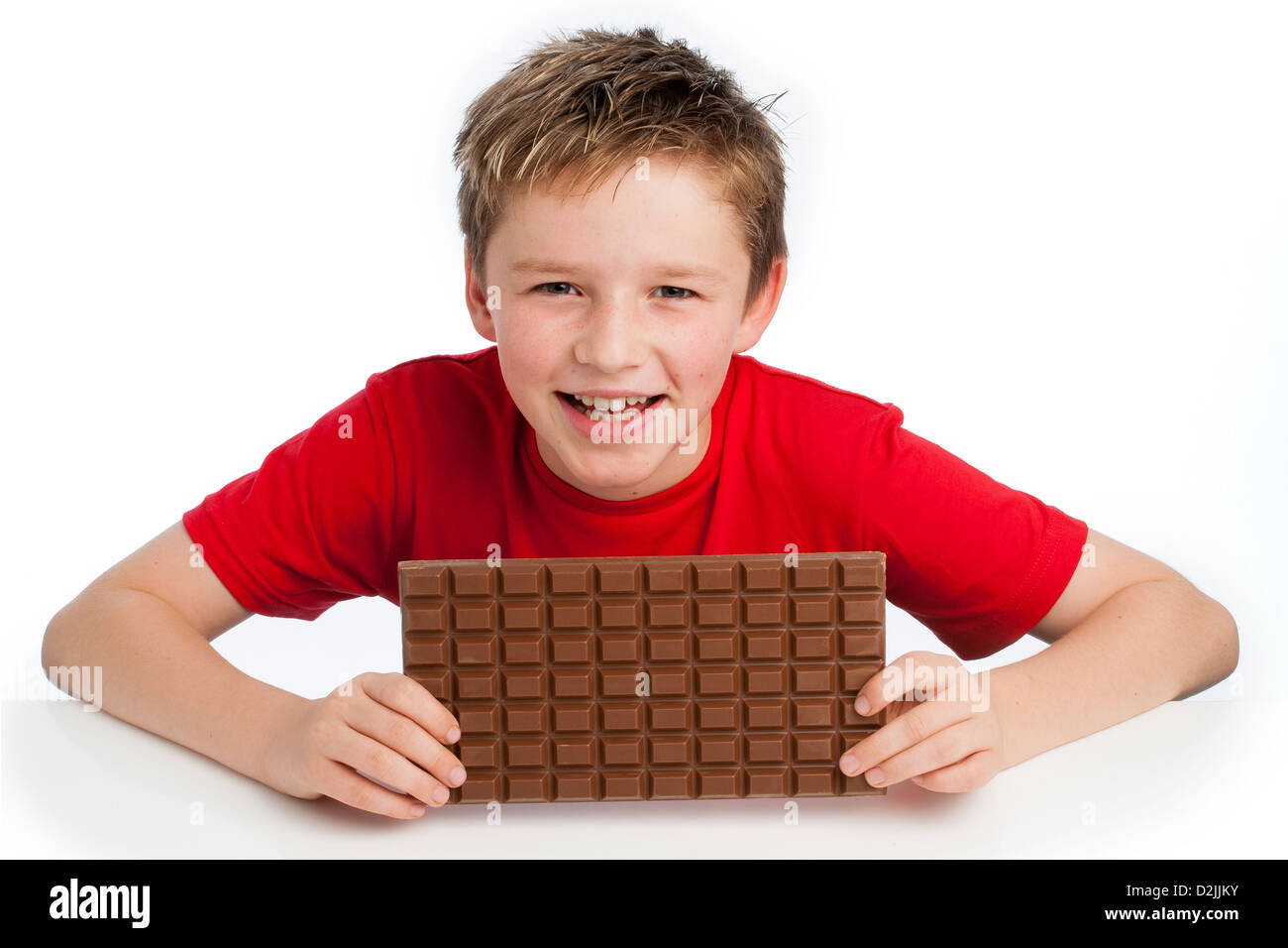 Cute smiling young boy eating very big slab of chocolate Stock Photo ...