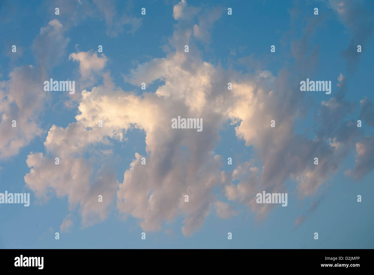 Backlit clouds against a clear blue sky background Stock Photo - Alamy