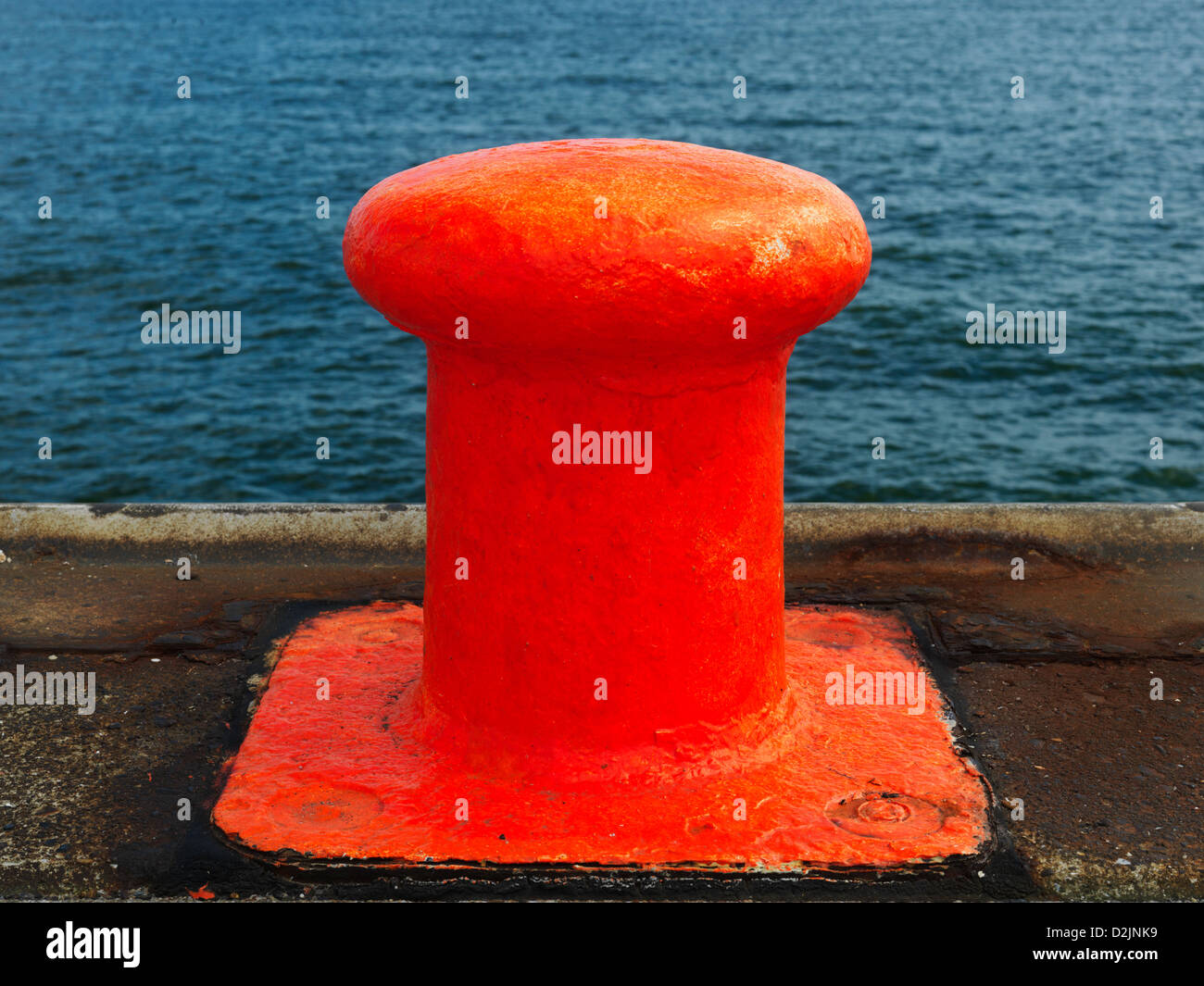 Helgoland, Germany, bright red painted bollards on the quay wall of ...
