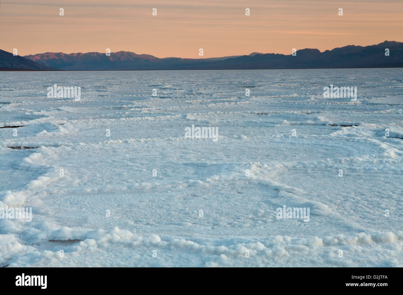 Salt pan polygons below the Black Mountains at Badwater during sunset ...