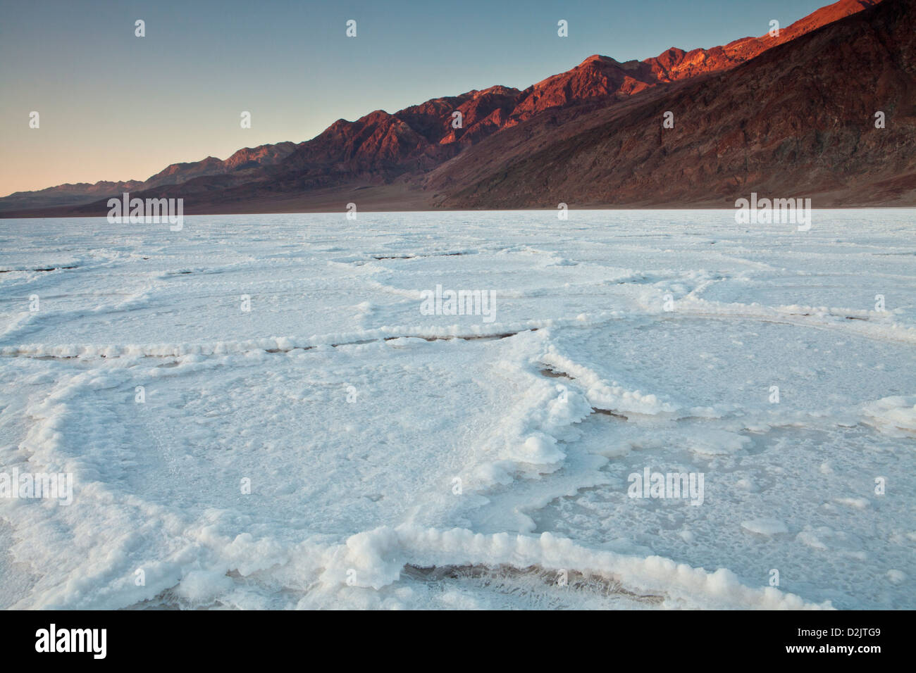 Salt pan polygons below the Black Mountains at Badwater during sunset ...