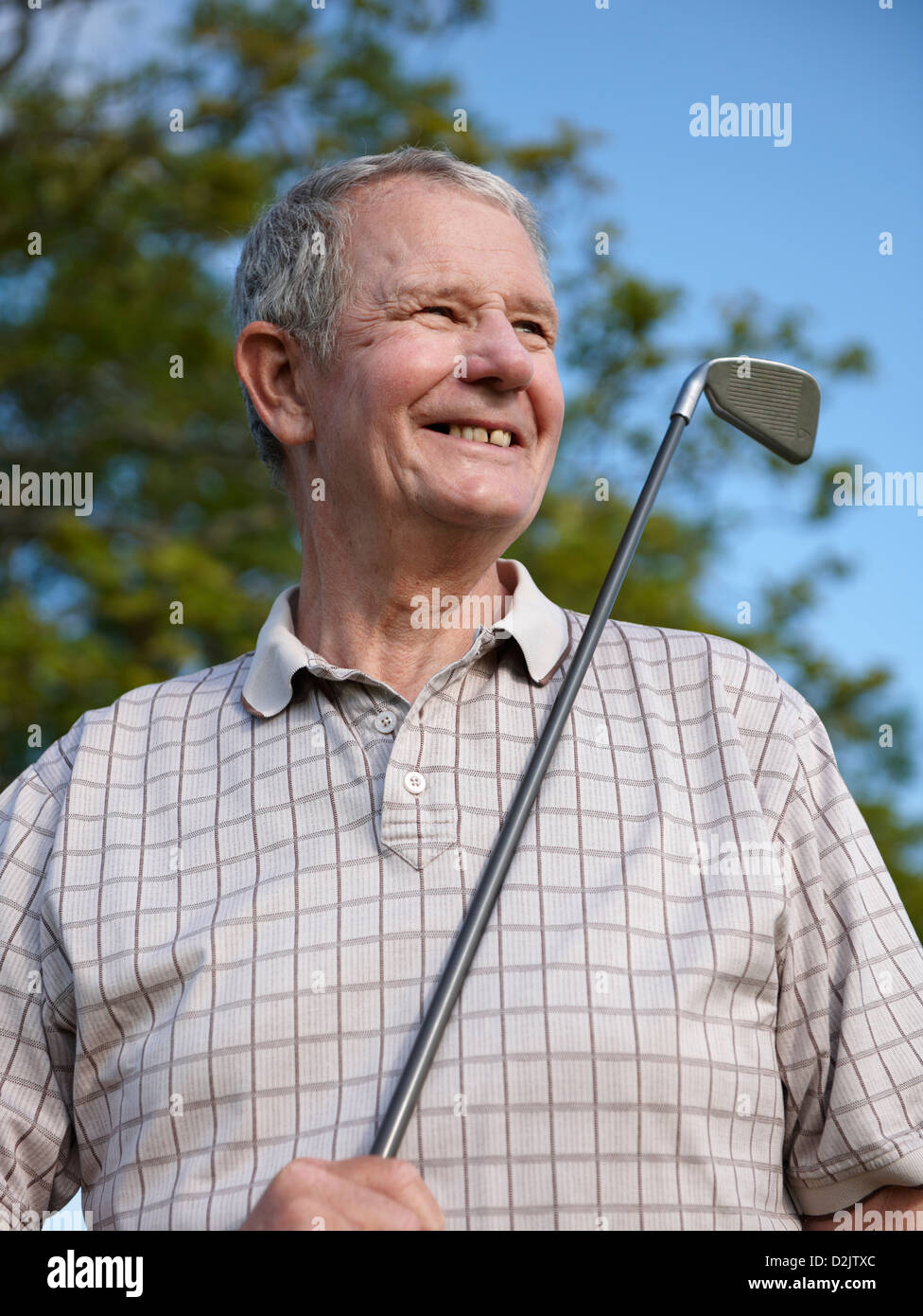 Golfer with golf club Stock Photo - Alamy