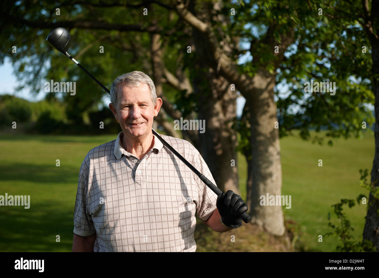 Golfer with golf club Stock Photo - Alamy