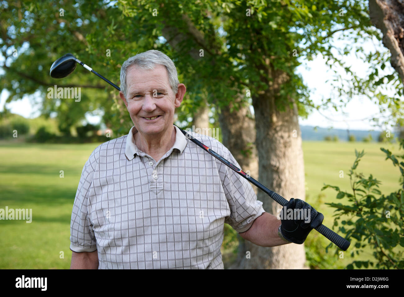 Golfer with golf club Stock Photo - Alamy