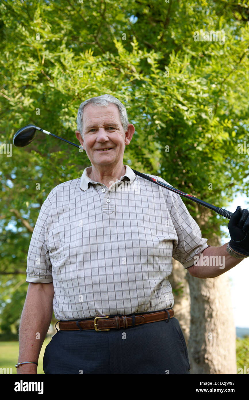 Golfer with golf club Stock Photo - Alamy