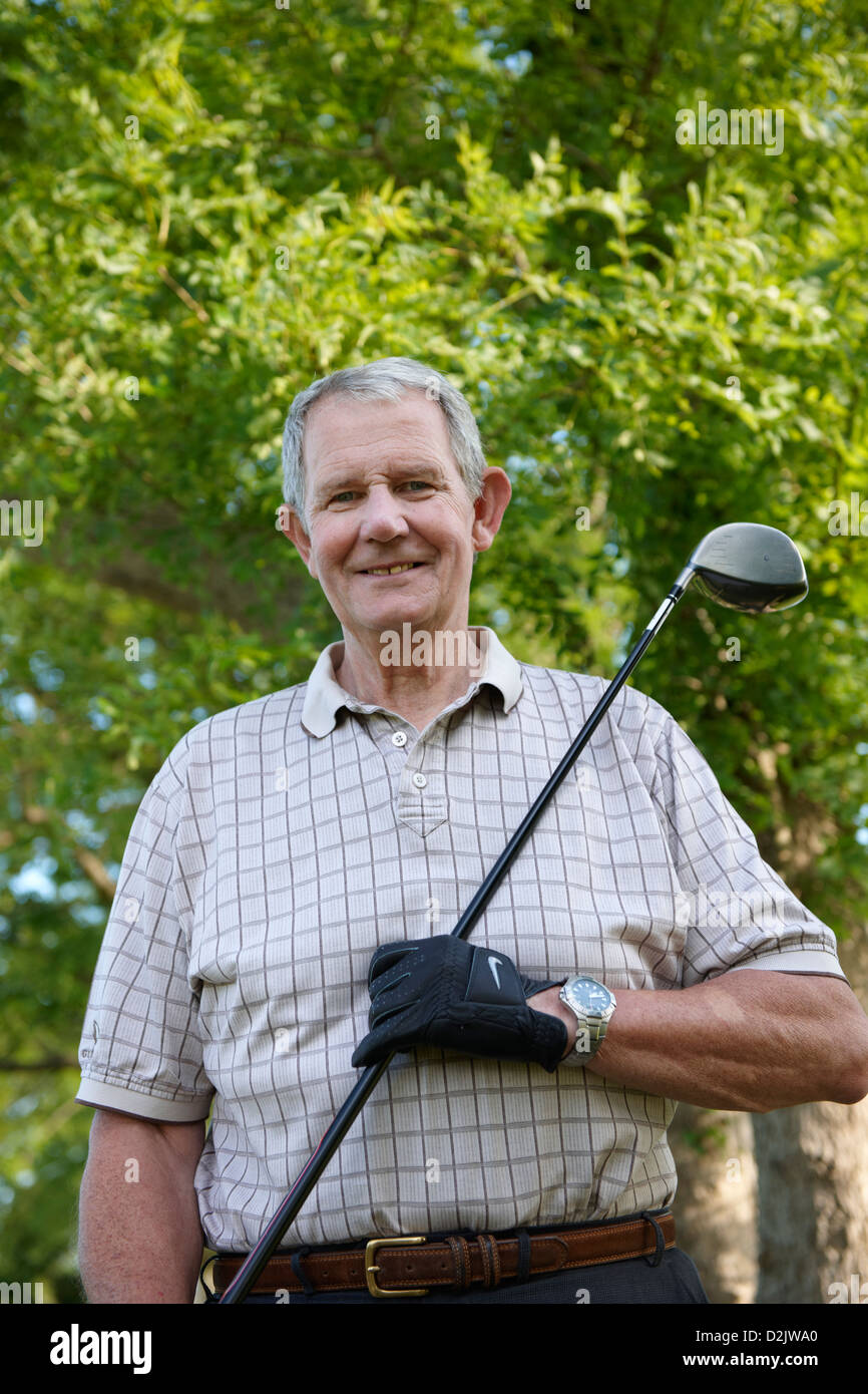 Golfer with golf club Stock Photo - Alamy