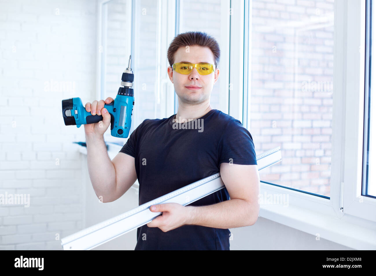 Man worker after installing new windows Stock Photo - Alamy