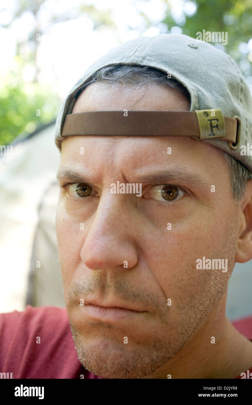 Photo of an attractive, but intense man in a baseball cap Stock Photo ...