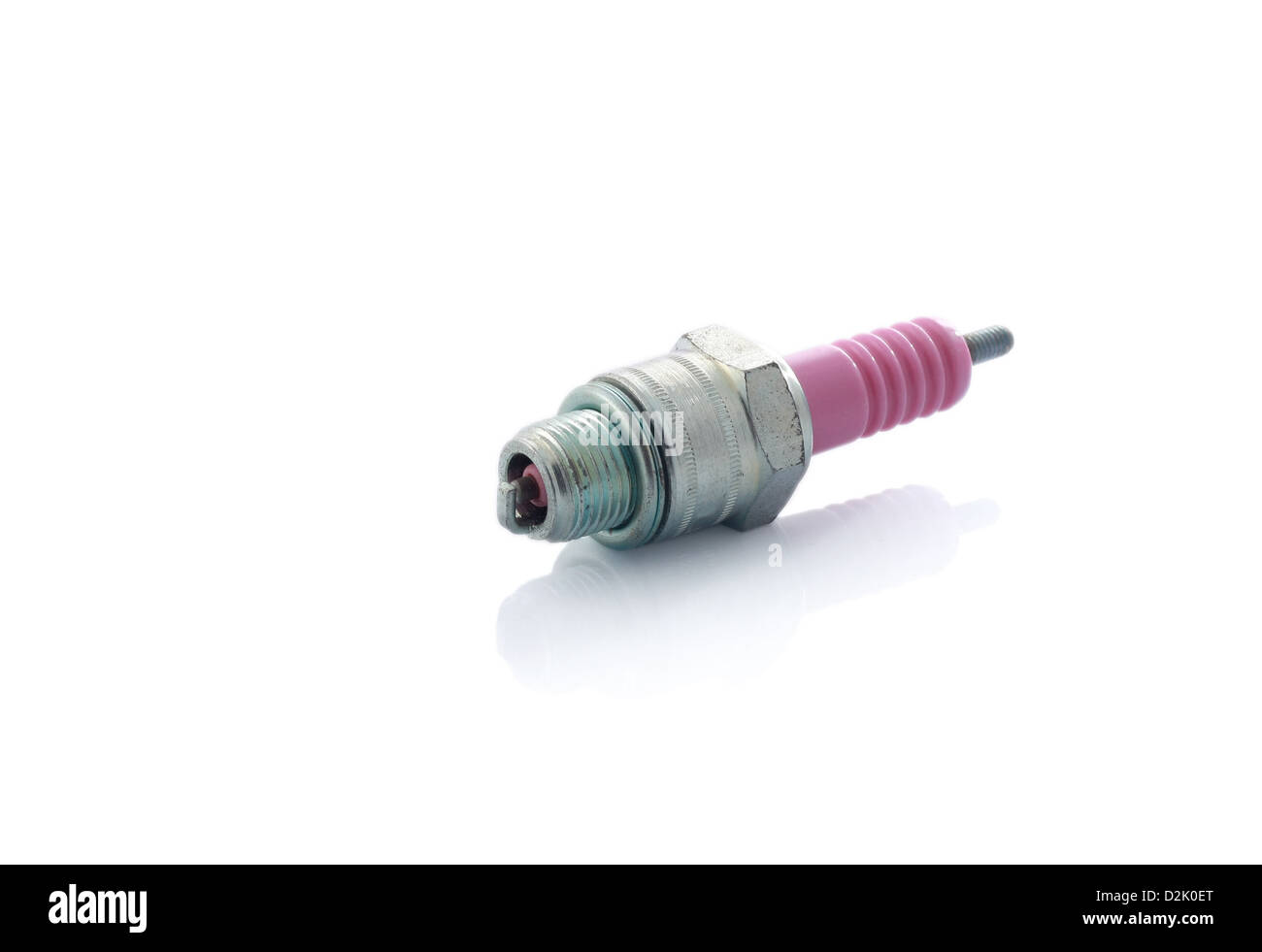 Old pink ceramic and steel spark plug isolated on white with reflection ...