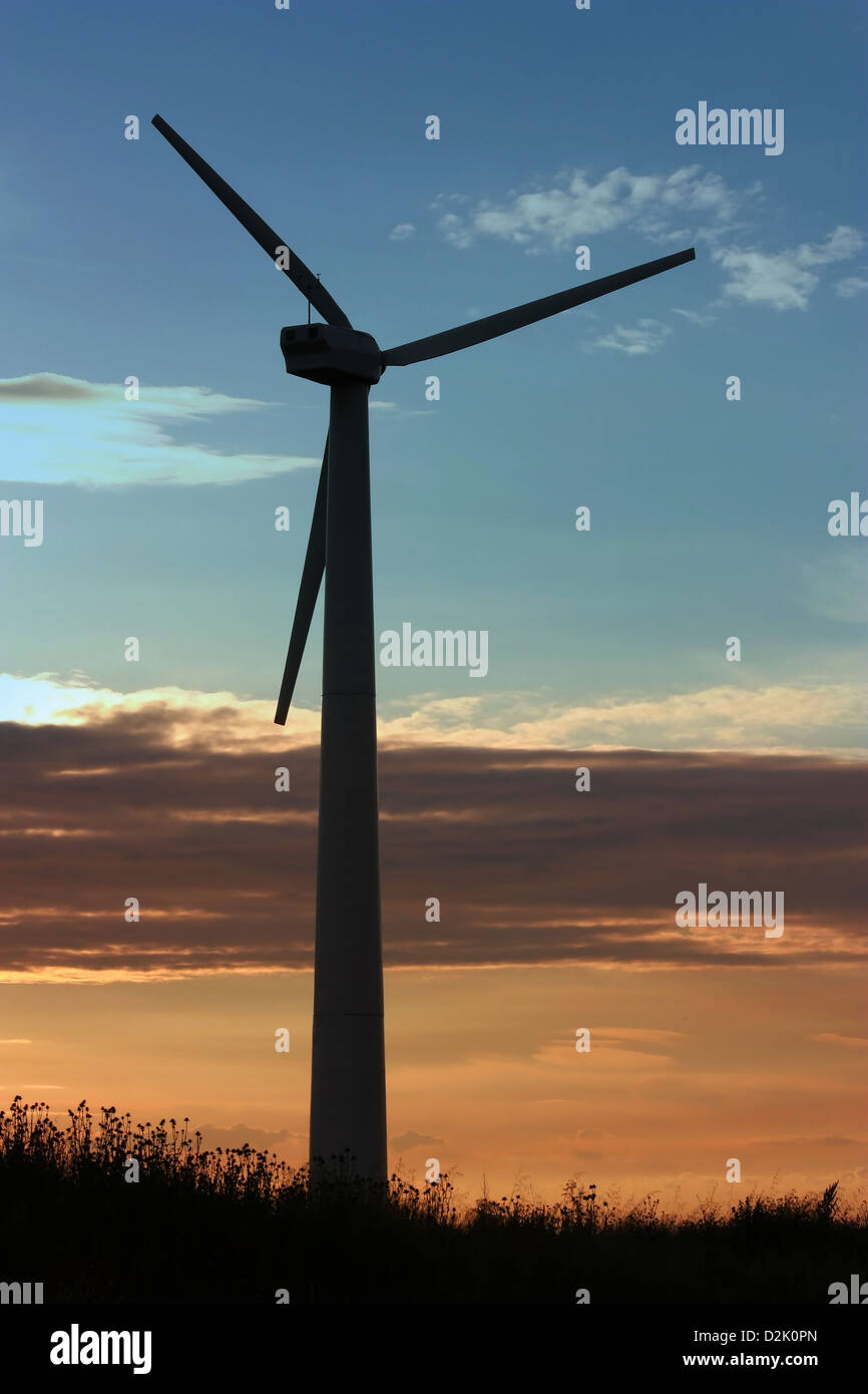 Windmill silhouette against cloudy sunset background Stock Photo - Alamy