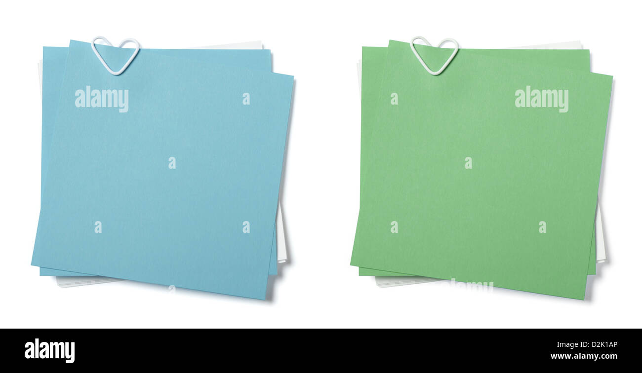 blue, green and white sticky notes with paper clip in shape of heart on ...