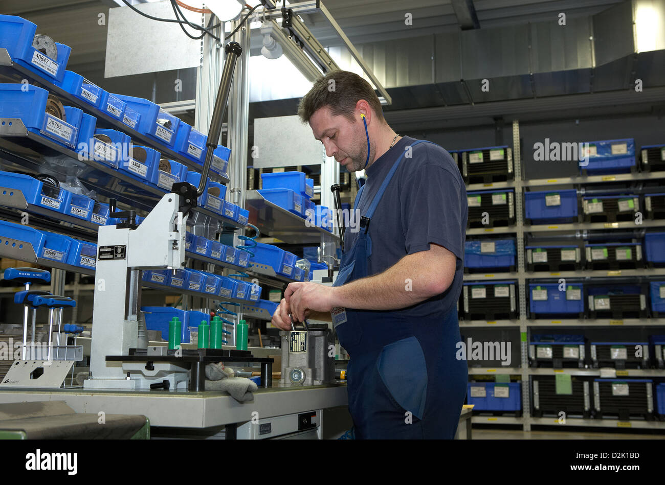 Berlin, Germany, employees in the assembly of a component for hydraulic ...