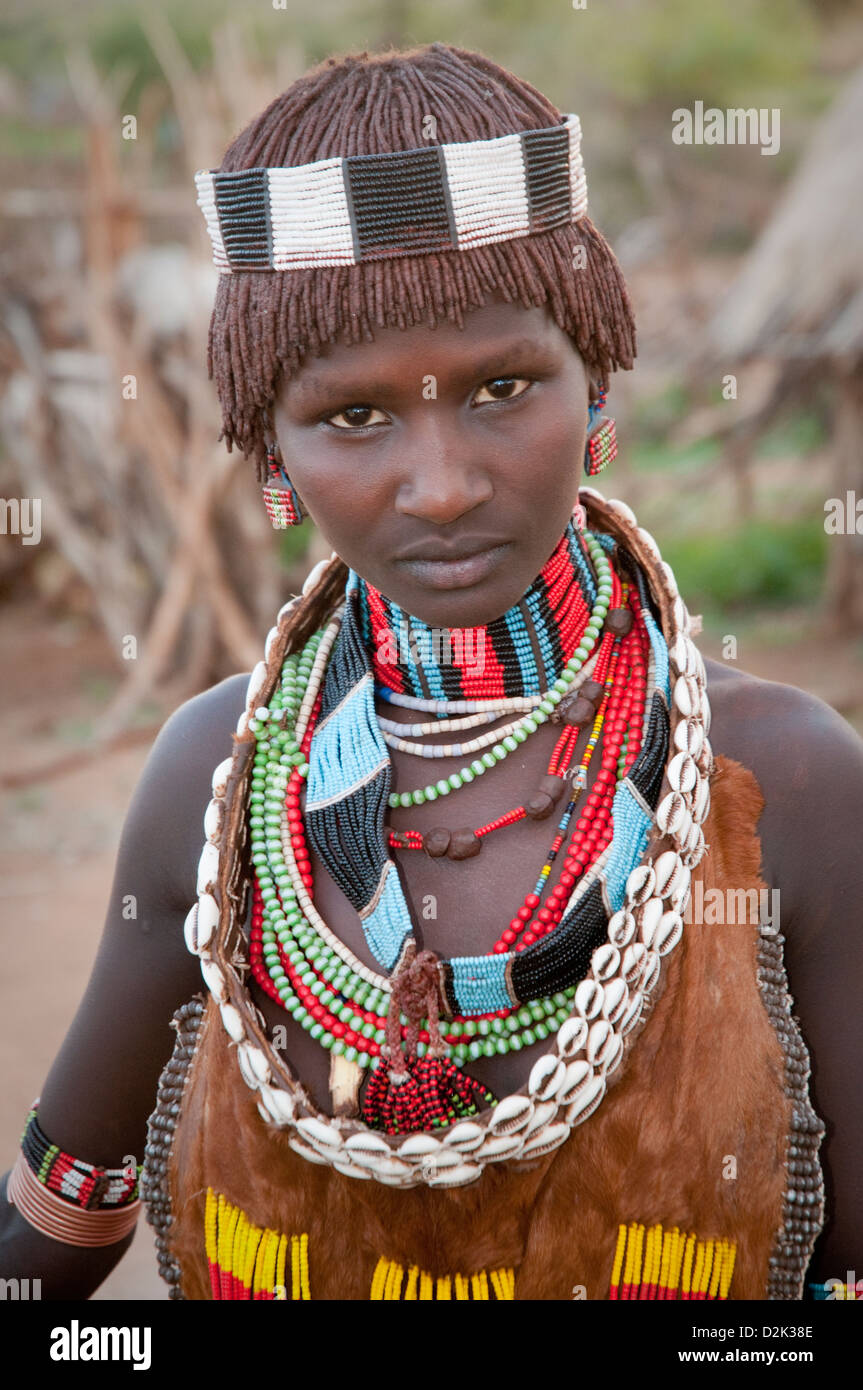 Portrait of lovely Hamar woman with ocre in hair and beautiful beaded ...