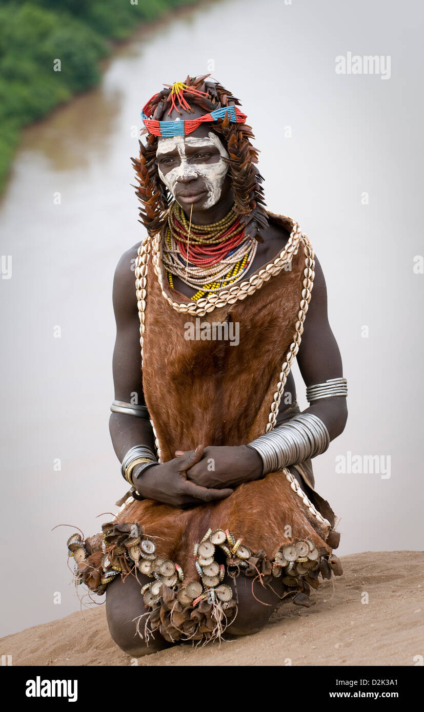 Portrait of Kara woman squatting-with her necklaces and jewelry. Omo ...