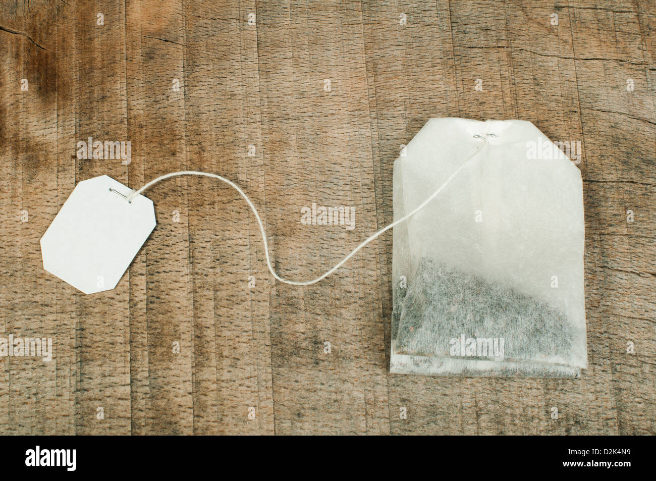 Tea bag with white label on wood plank Stock Photo - Alamy