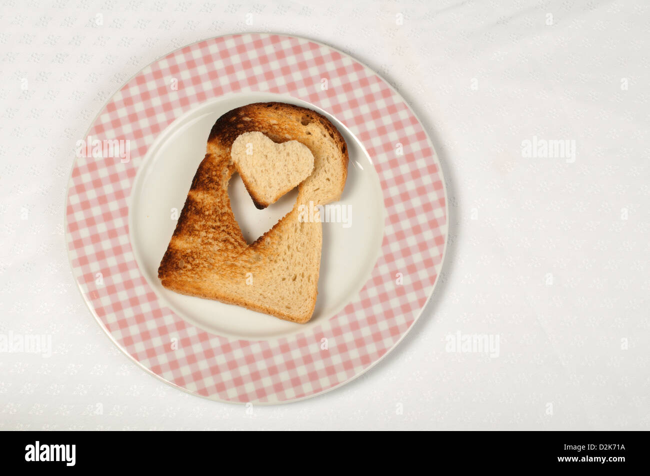 Toast with heart-shaped set in white plate Stock Photo - Alamy