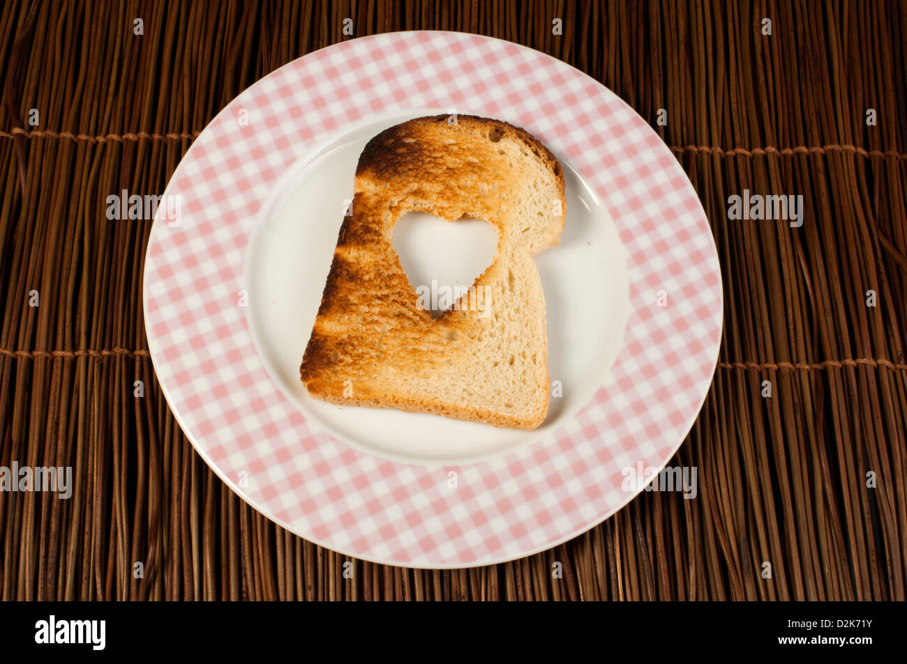 Toast with heart-shaped set in white plate Stock Photo - Alamy