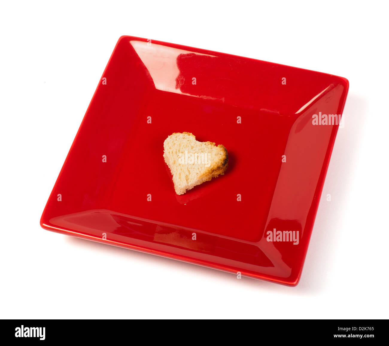 Toast with heart-shaped set in red plate Stock Photo - Alamy