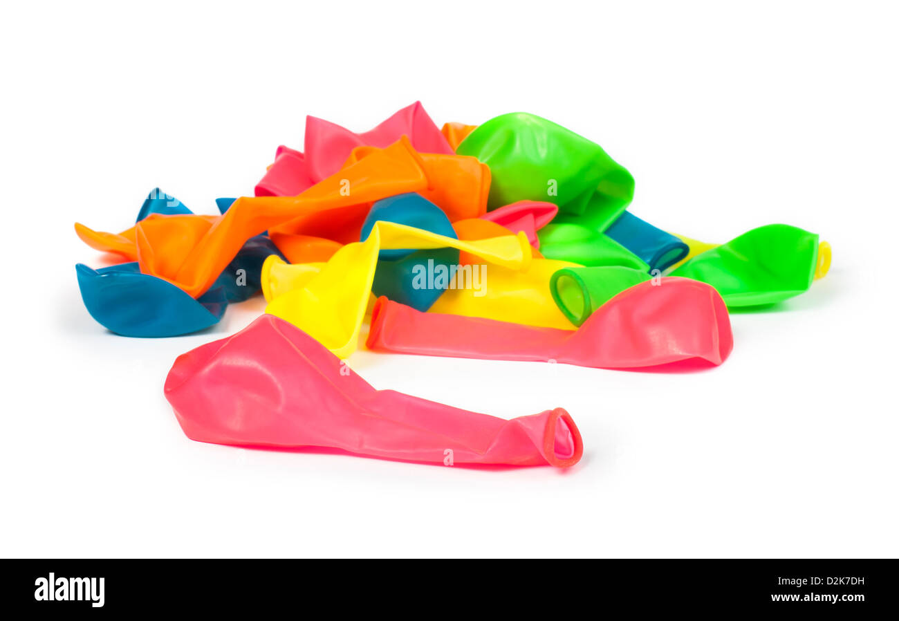 Pile of uninflated balloons from different colors. White isolated Stock ...