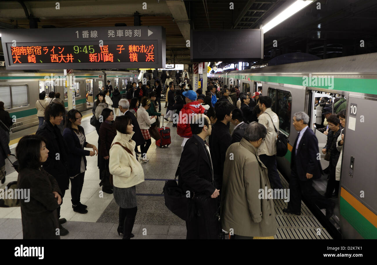 Tokyo, Japan, people on a regional train platform of Shinjuku Station ...