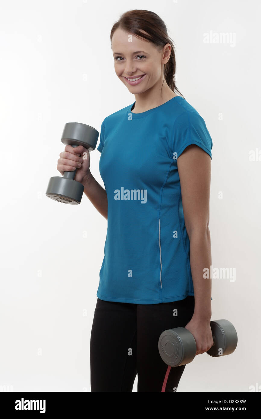 attractive woman doing a workout routine with a dumbbell weights Stock ...