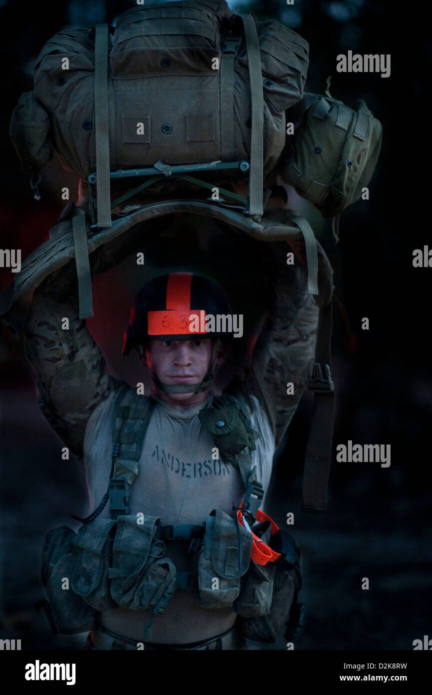 A US Air Force tactical air control trainee lifts a 100-pound ruck sack ...