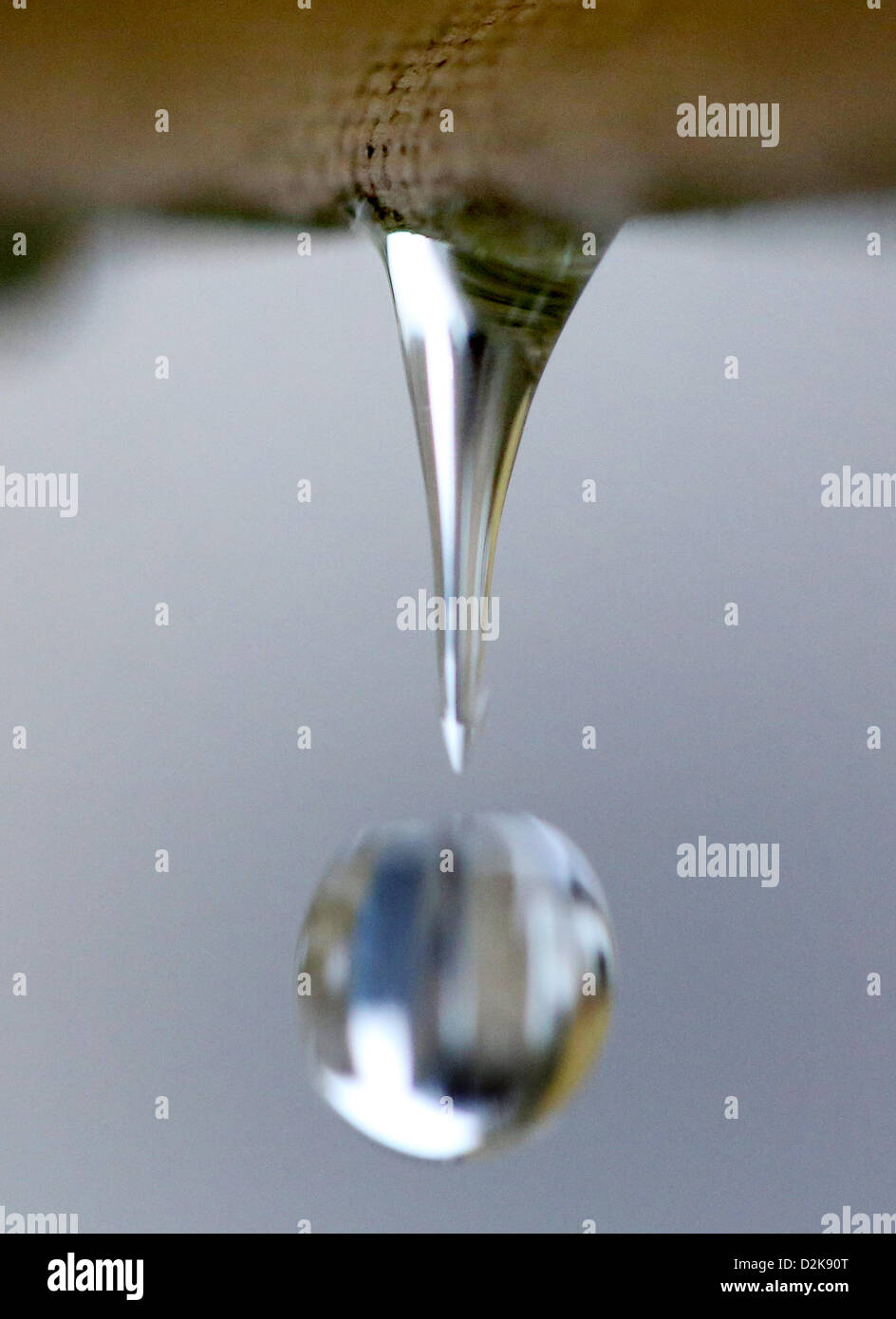 Water drops from melting snow fall from a roof in Neukirchen-Vluyn ...