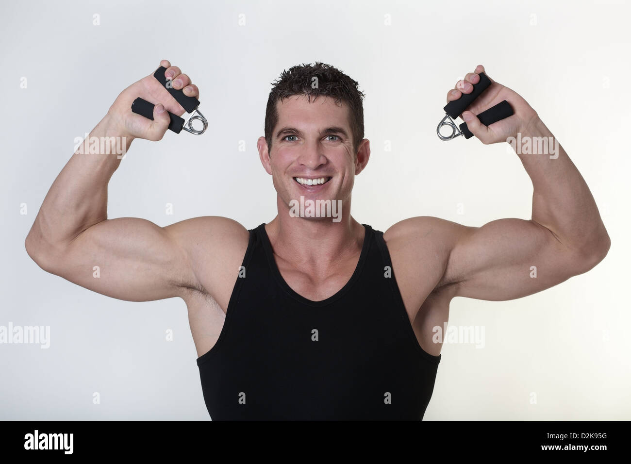 good looking male bodybuilder using hand gripper Stock Photo - Alamy