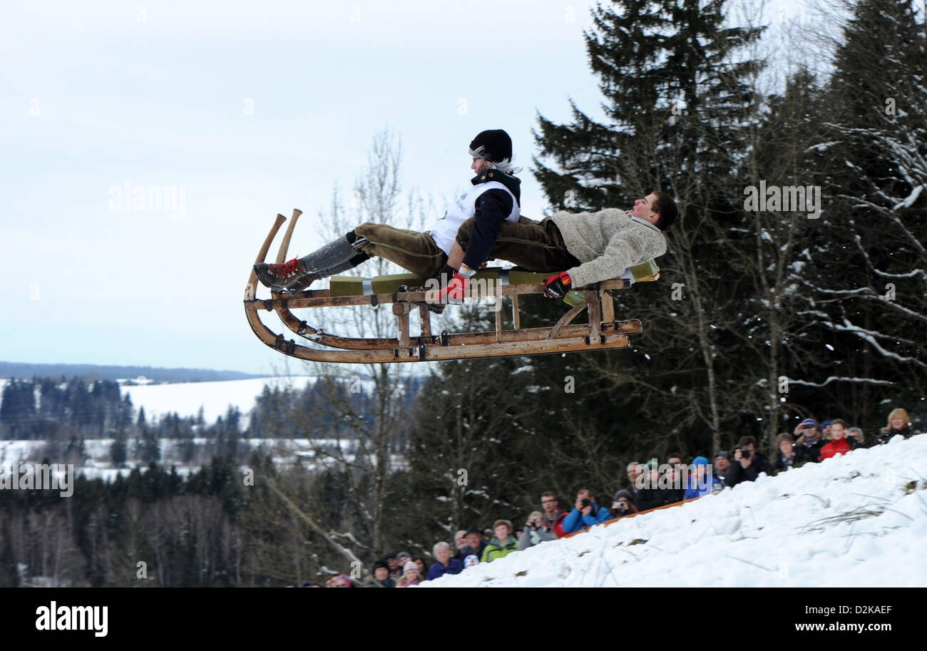 Two people race horn sleds during the traditional Schnablerrennen sled ...