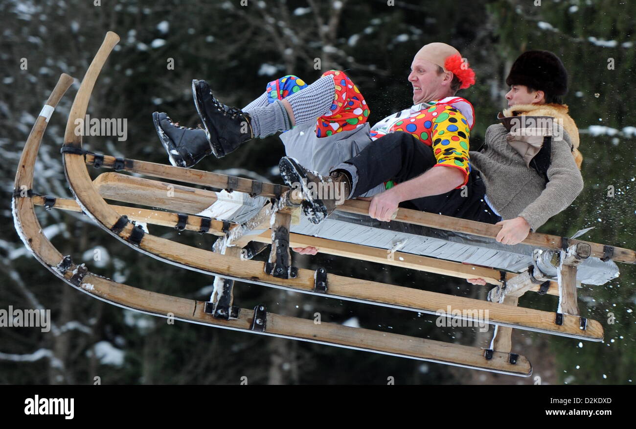 Two people race horn sleds during the traditional Schnablerrennen sled ...