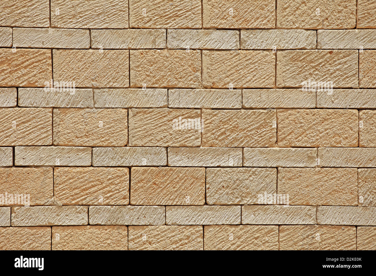 Yellow natural limestone brick wall background with front and side ...