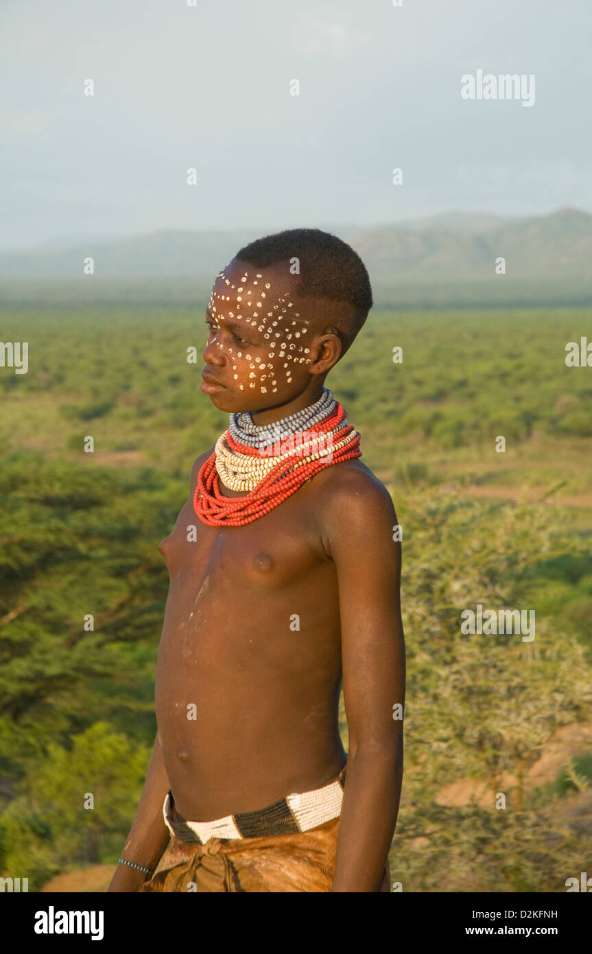 Portrait of decorated Kara woman on bluff overlooking Omo Valley-close ...