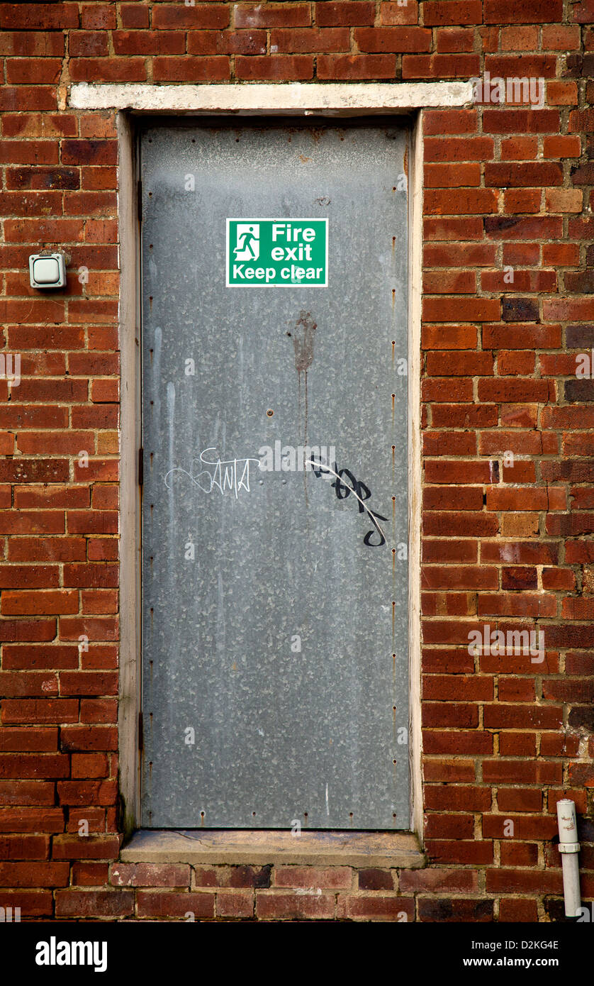 A rusty old fire exit door and sign Stock Photo - Alamy
