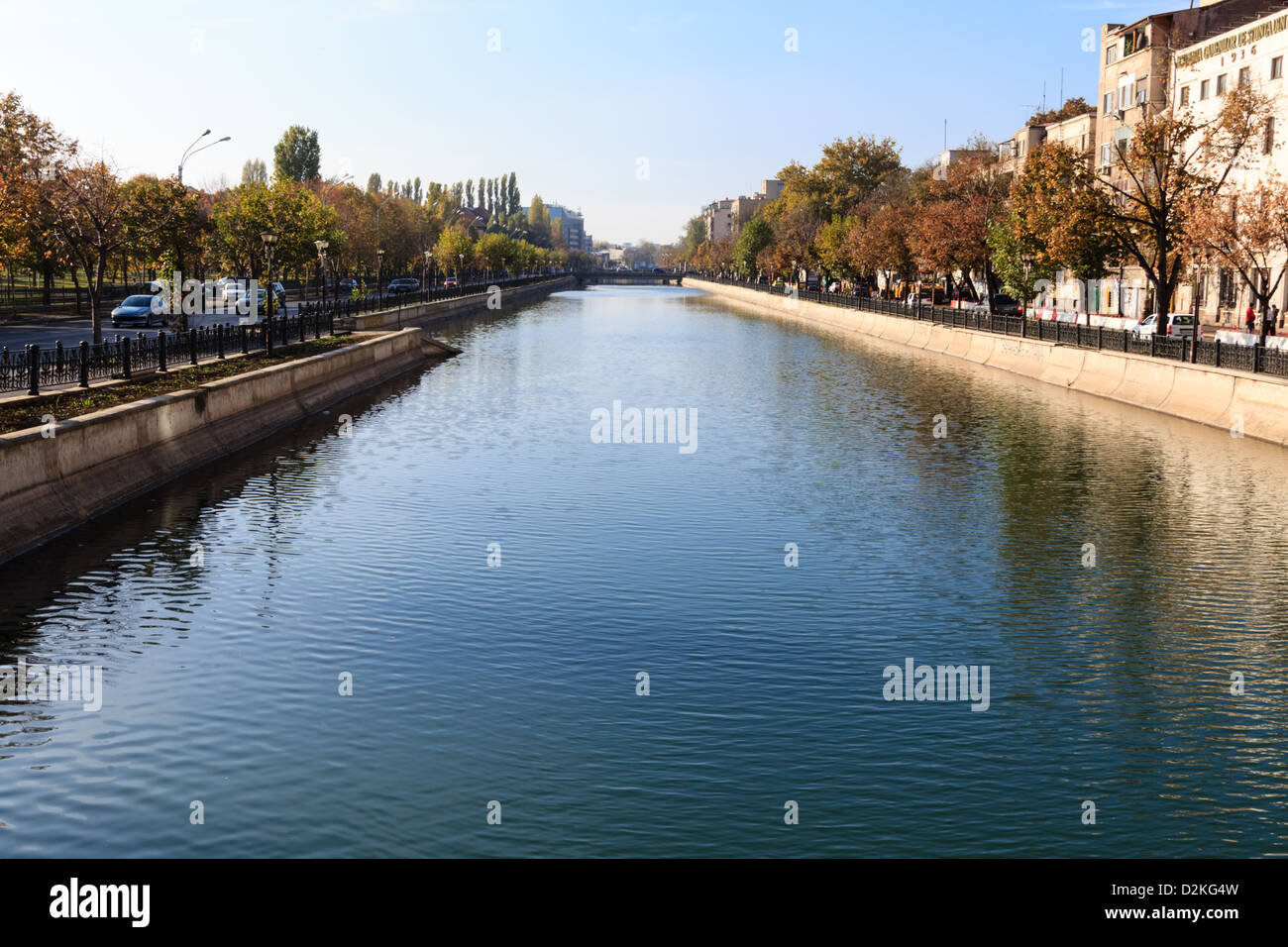 Bucharest's river Dambovita with streets and fall trees next to it ...